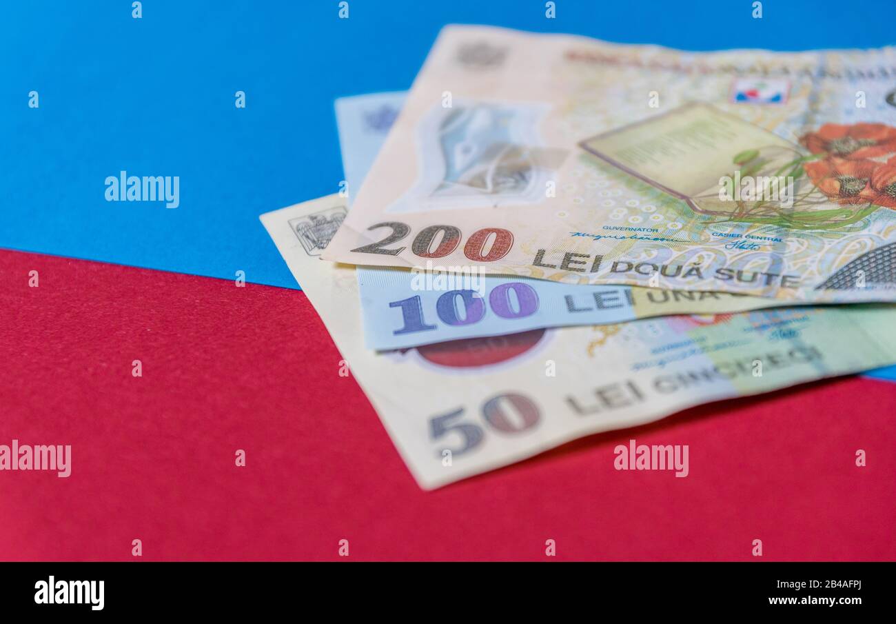Romanian banknotes on a blue and red background. Coloseup of RON ...