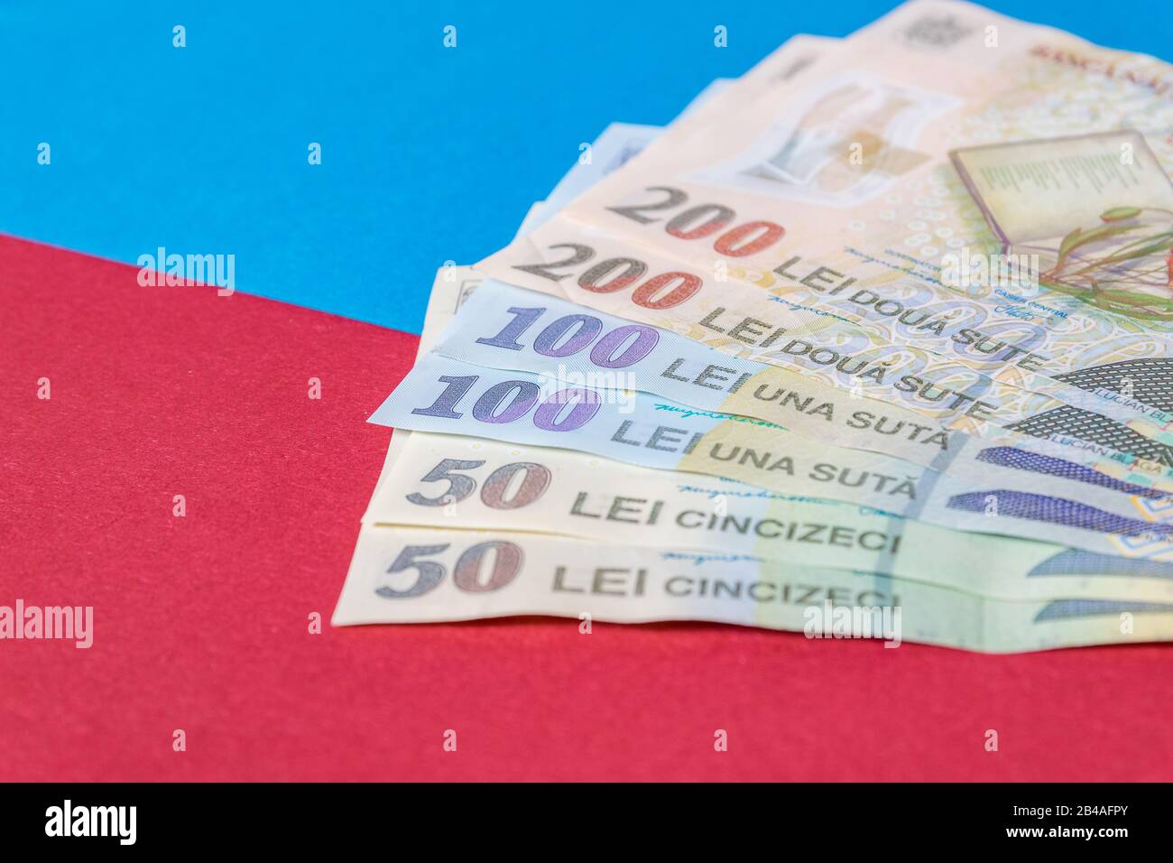 Romanian banknotes on a blue and red background. Coloseup of RON ...