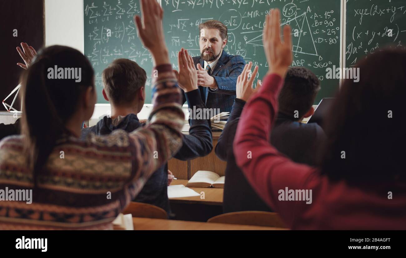 Teacher choosing student to answer Stock Photo - Alamy