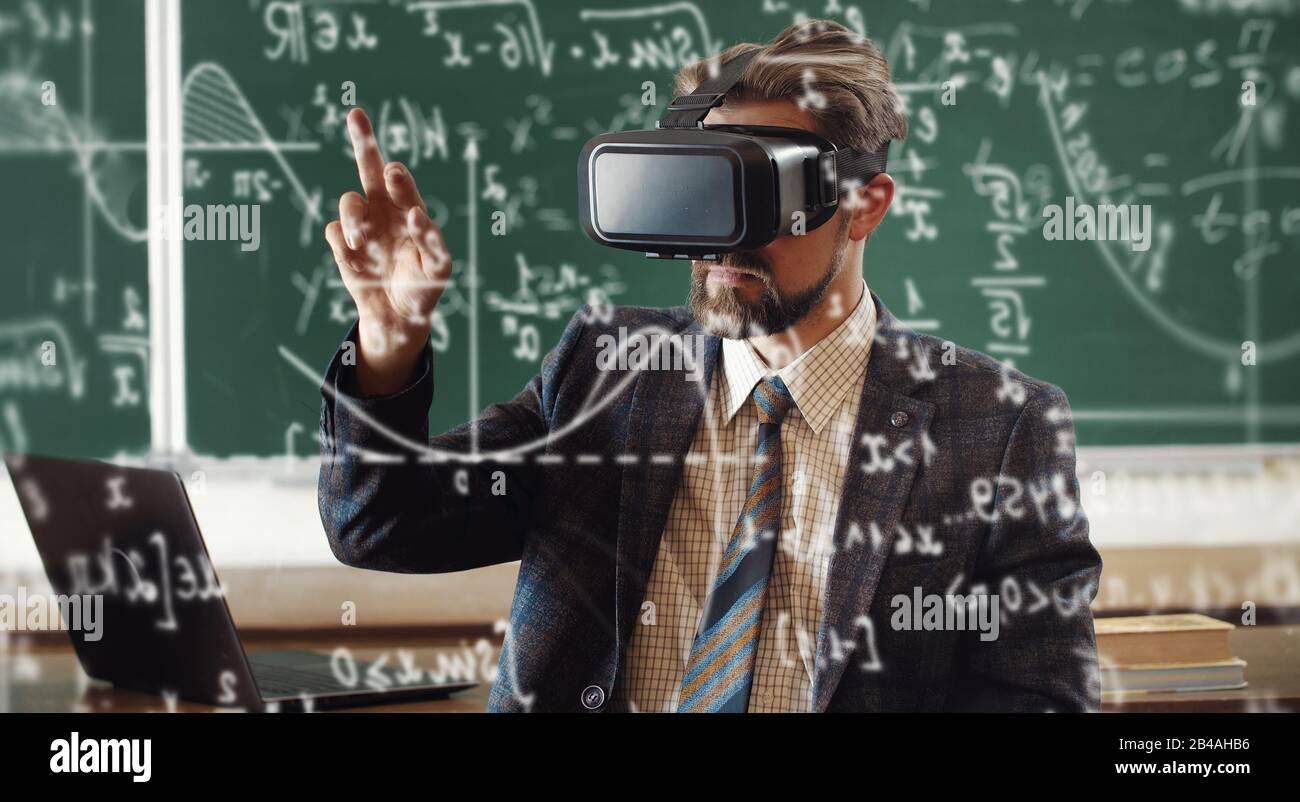 Teacher wearing virtual reality headset Stock Photo - Alamy