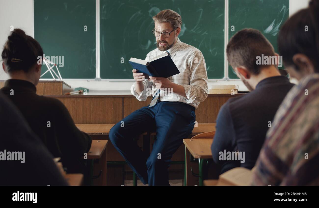 Students listening to teacher's reading Stock Photo - Alamy
