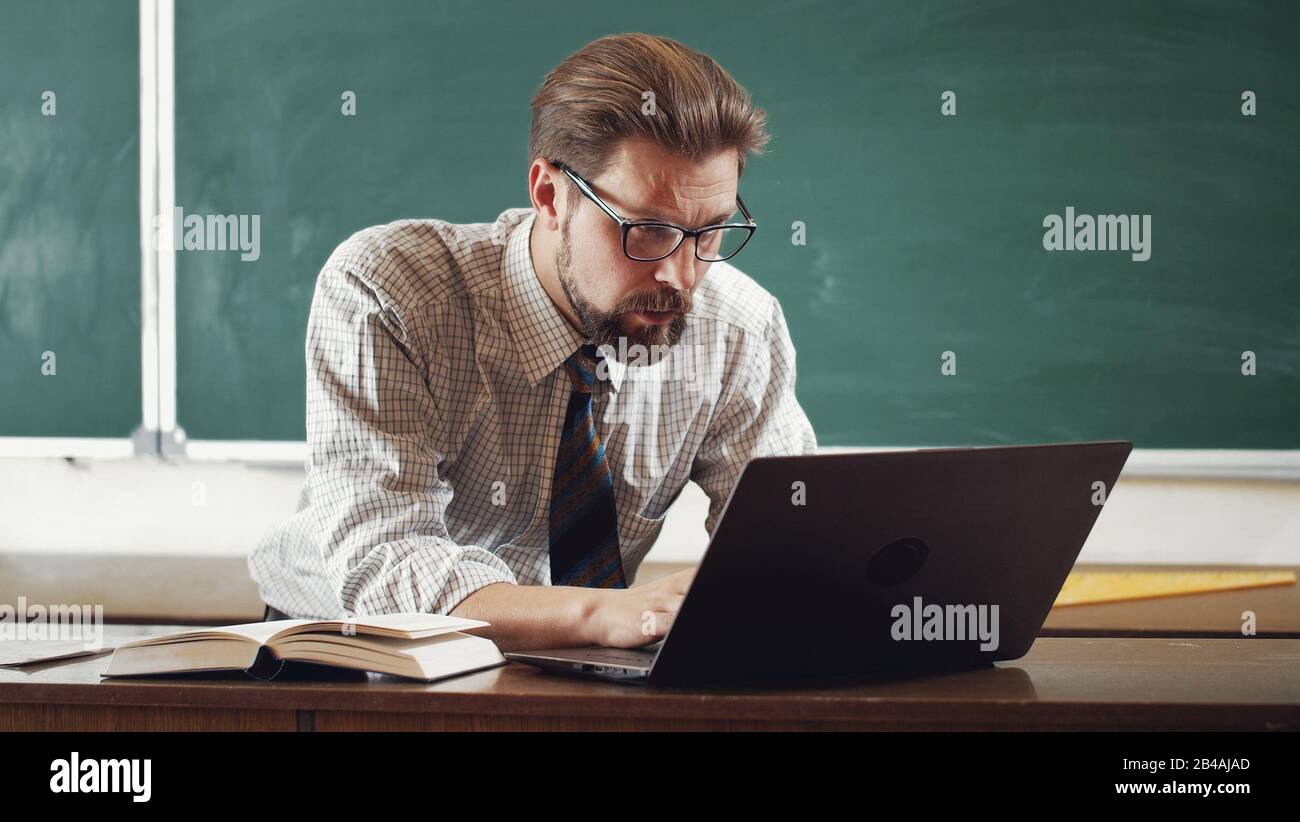 Teacher working in classroom Stock Photo - Alamy
