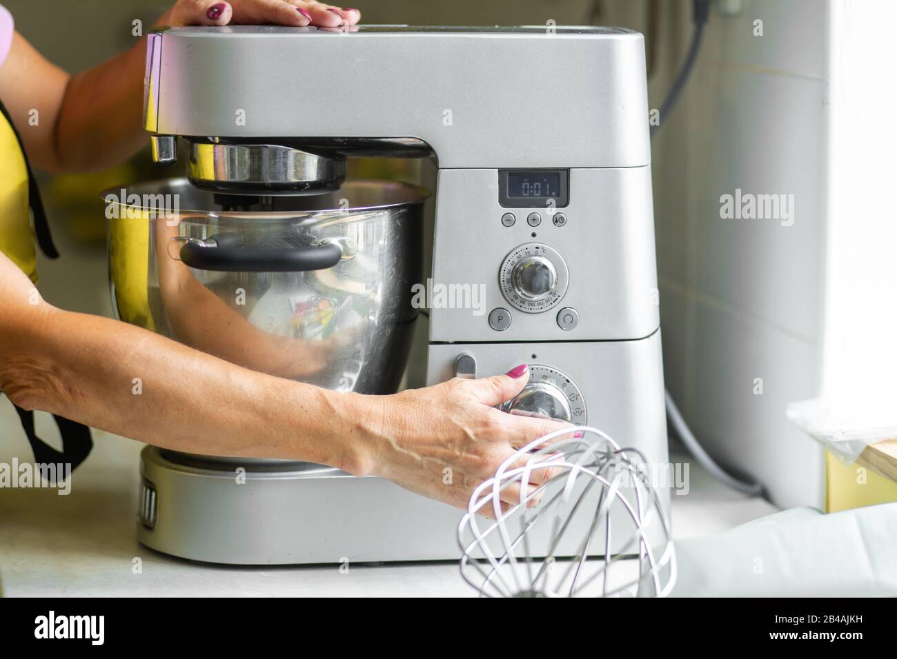 Woman professional pastry chef preparing a dessert. Adds ingredients ...