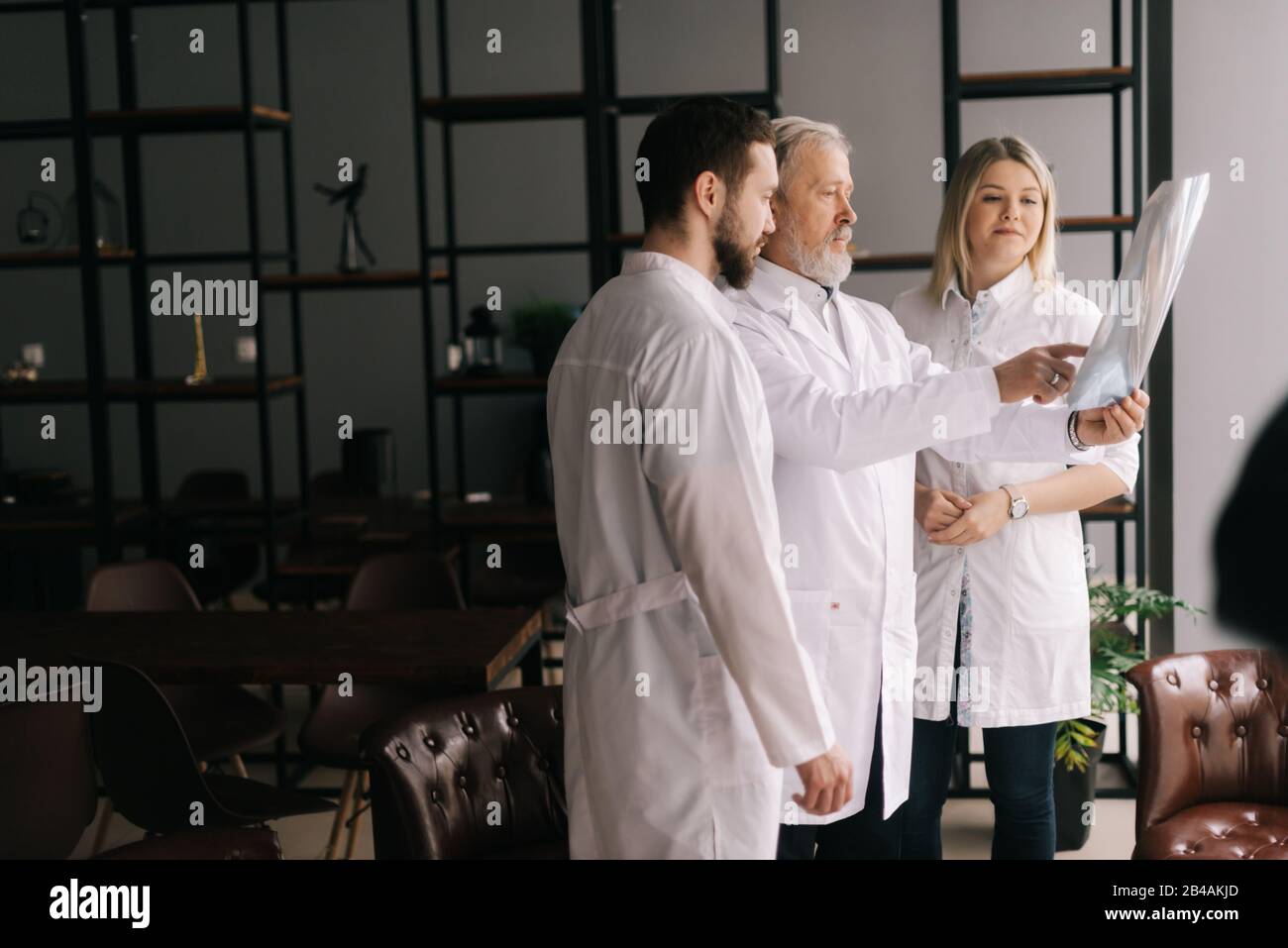 Group of three doctors examining X-ray scan together Stock Photo - Alamy