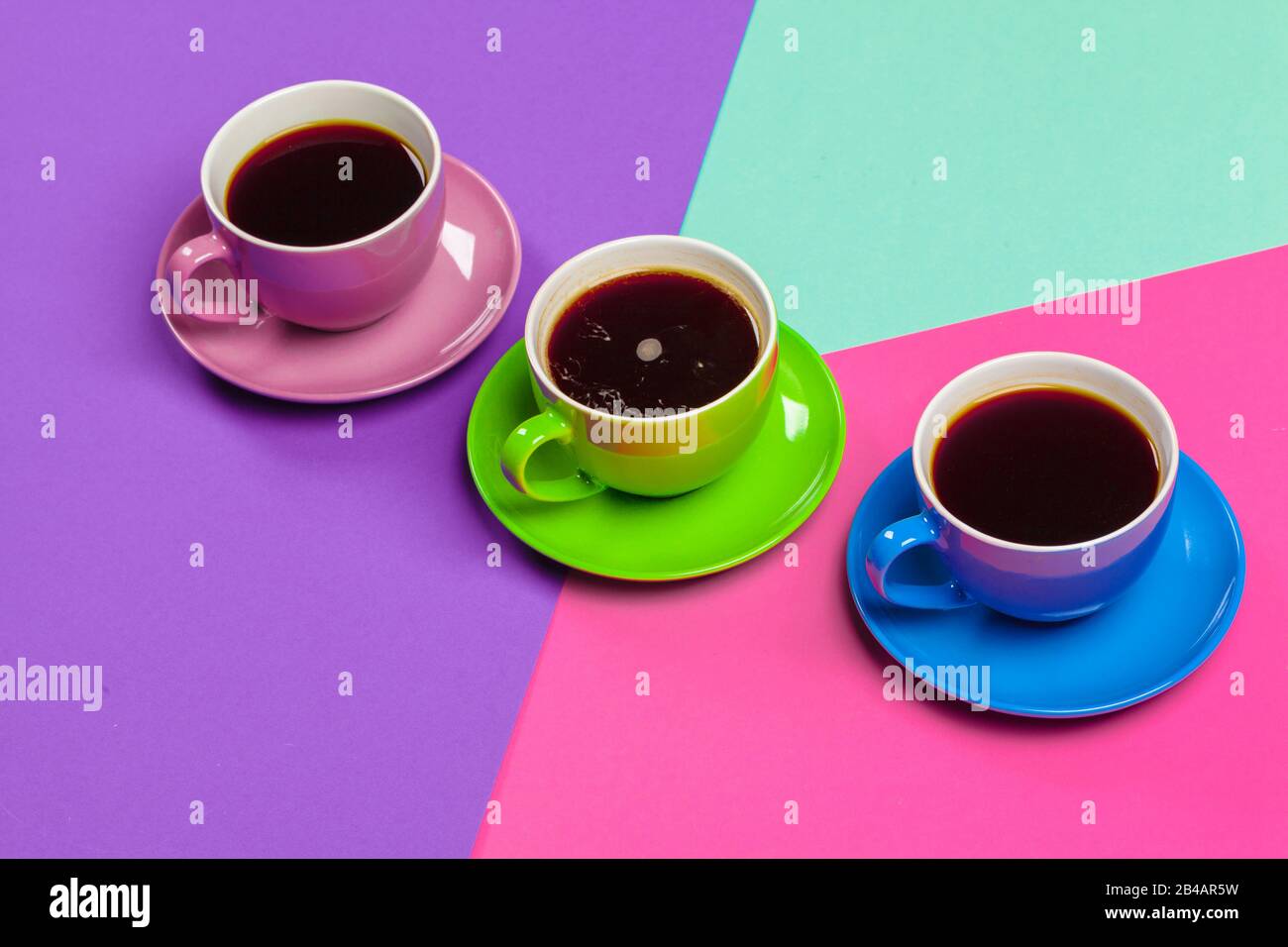 Colorful coffee cups and saucers on colorful vibrant background Stock ...