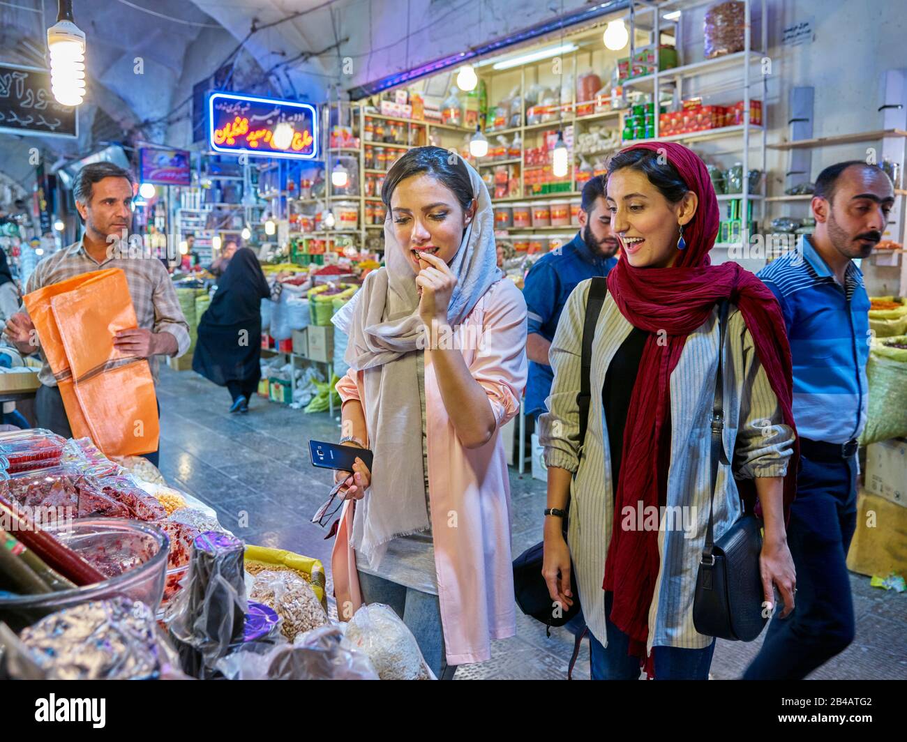 Two young women in the grand bazaar of the city of Isfahan in southern ...