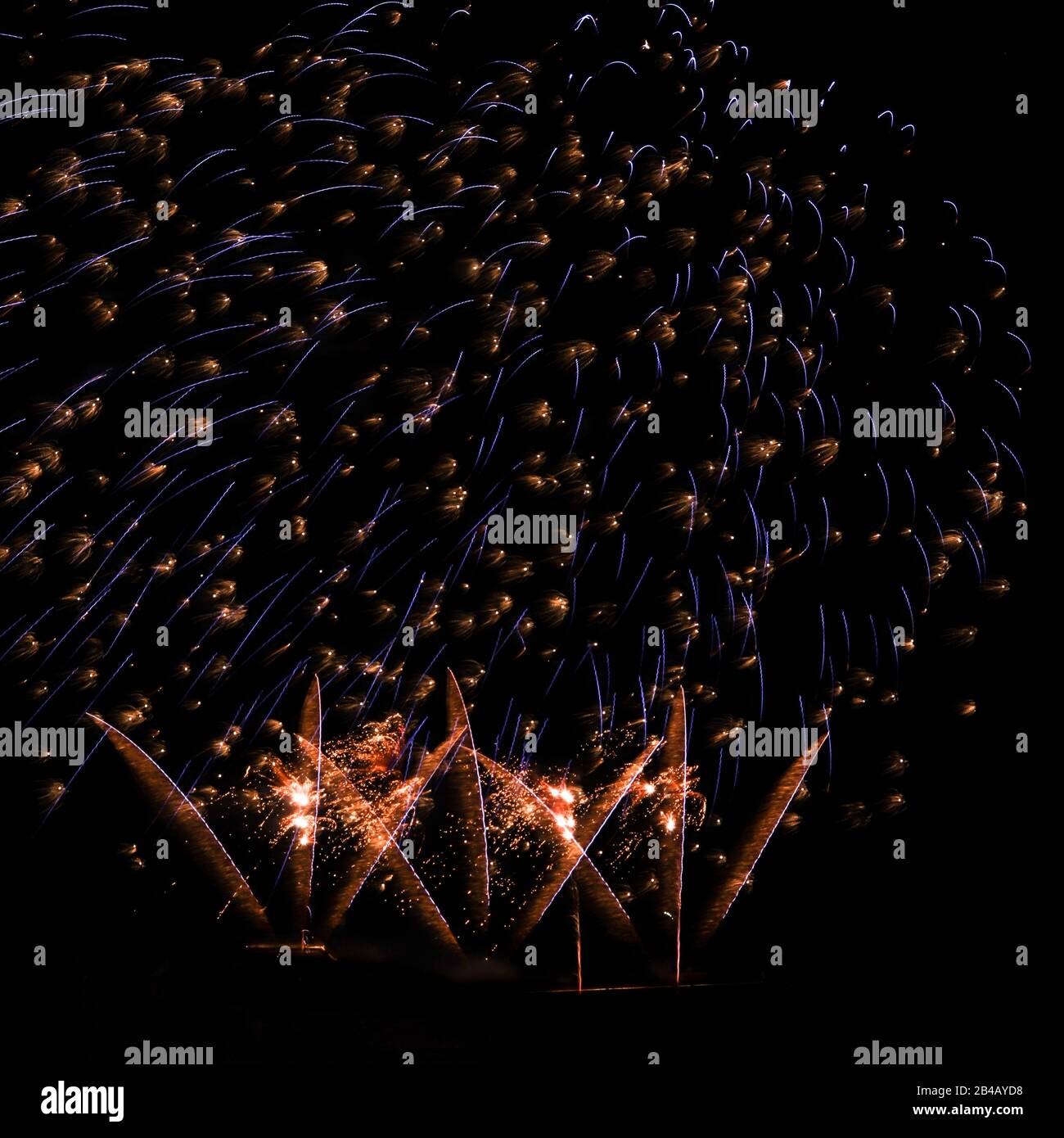 Amazing blue and gold fireworks against a black sky at an event in ...