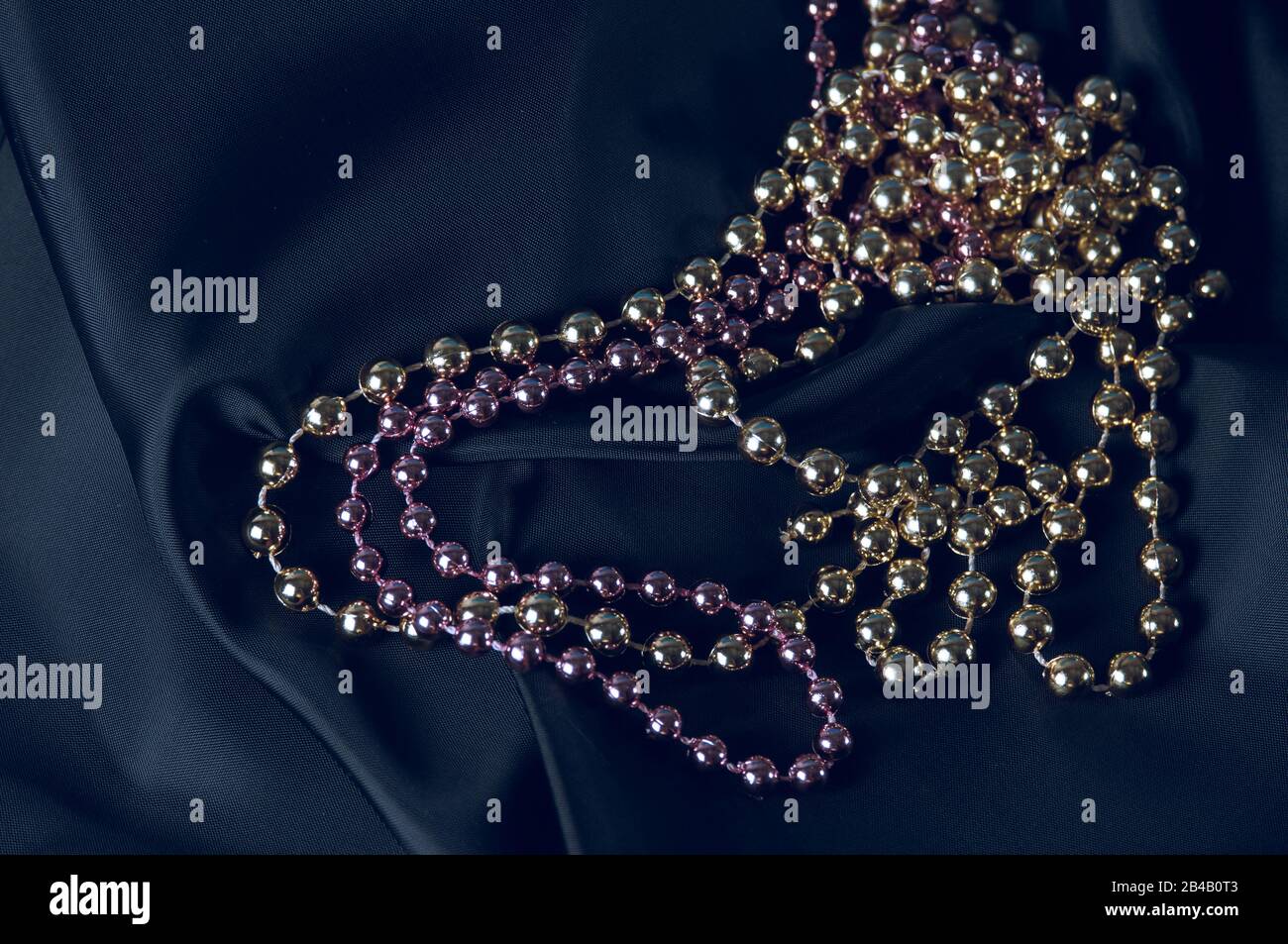 Mardi Gras beads on a black background. Carnival accessory Stock Photo ...