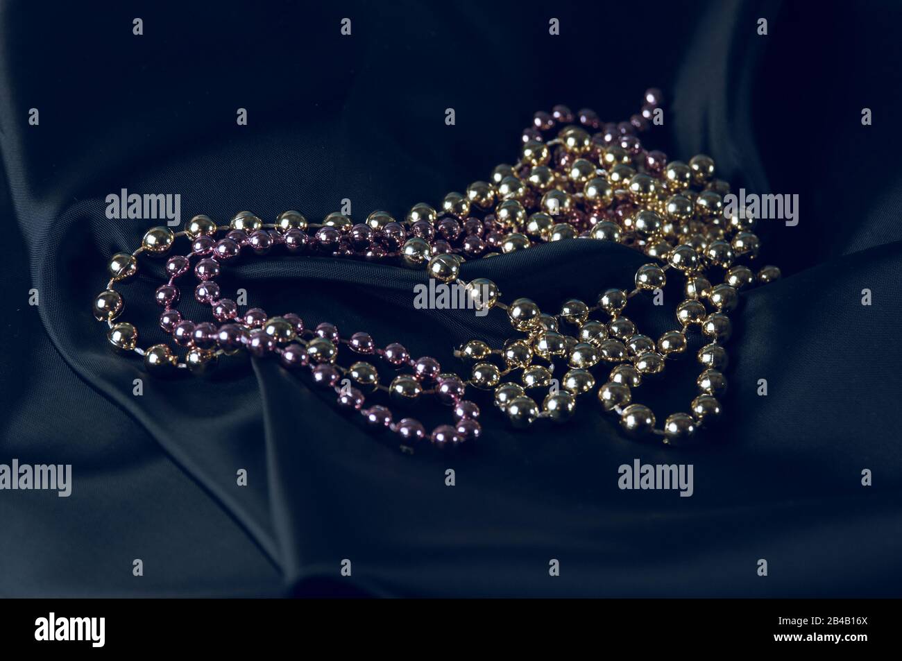 Mardi Gras beads on a black background. Carnival accessory Stock Photo ...