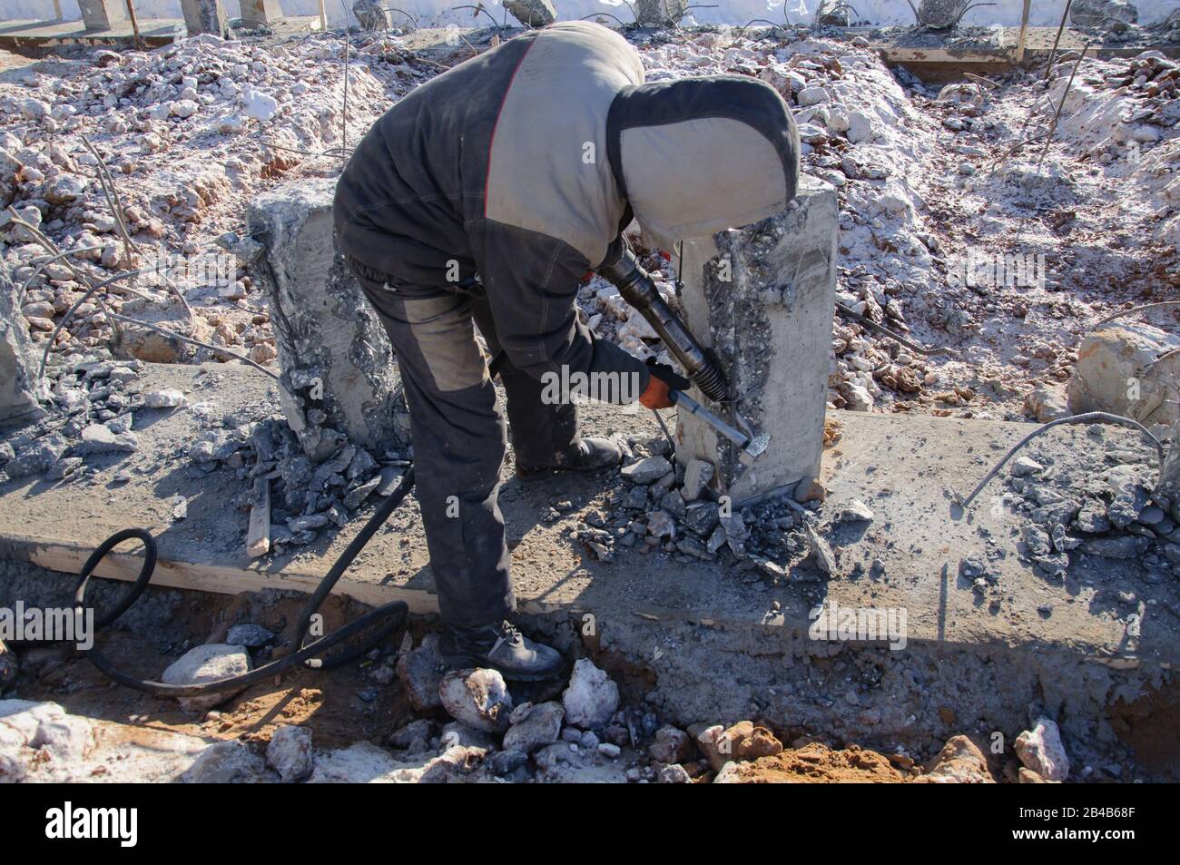 The process of dismantling works with a jackhammer. A worker beats the ...