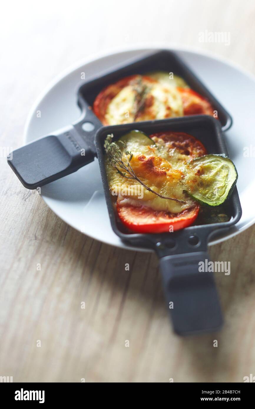 Melted cheese, zucchini goat cheese raclette Stock Photo - Alamy