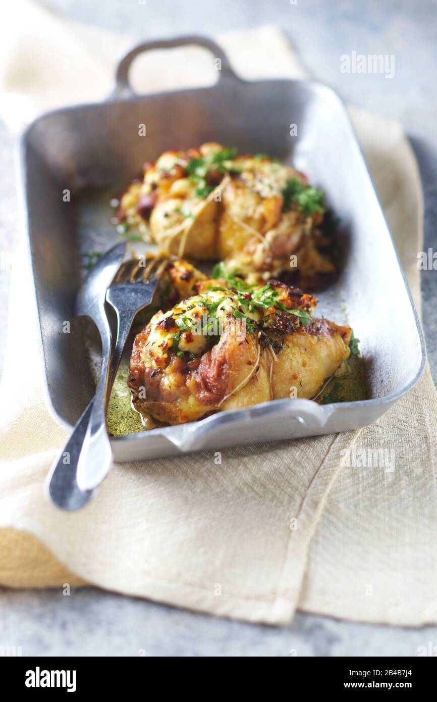 Chicken leg stuffed with cream cheese with herbs Stock Photo - Alamy