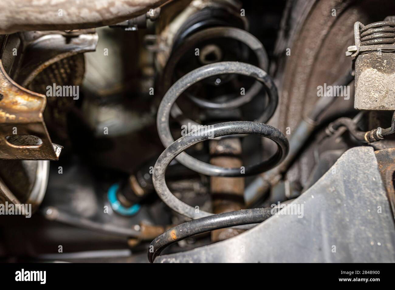 Rear car suspension from below, visible suspension springs, shock ...