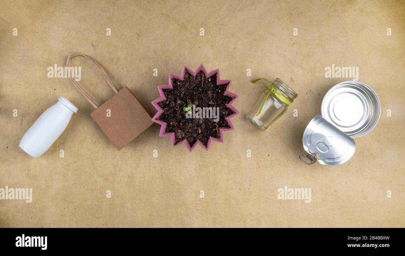 mix of garbage for recycling and green sprout, metal, plastic, paper ...