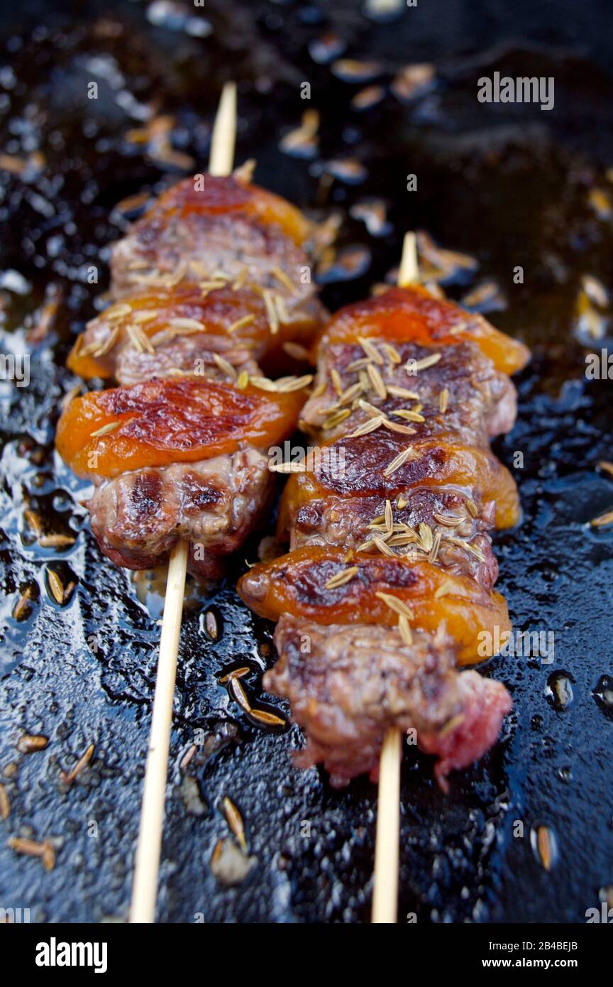 Plancha cooking, mini beef kebab and cumin dried apricots Stock Photo ...