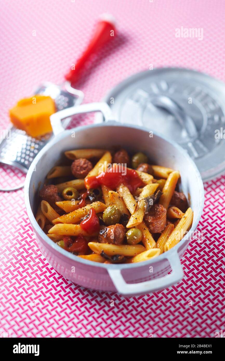 Ketchup dish, penne with spicy sausage and sage Stock Photo - Alamy