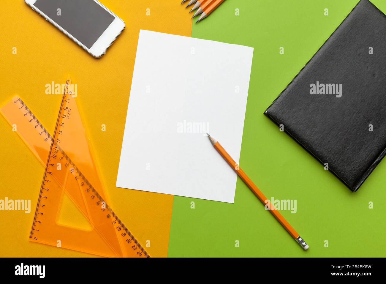 Blank paper with smart phone on desk.top view,flat lay Stock Photo - Alamy