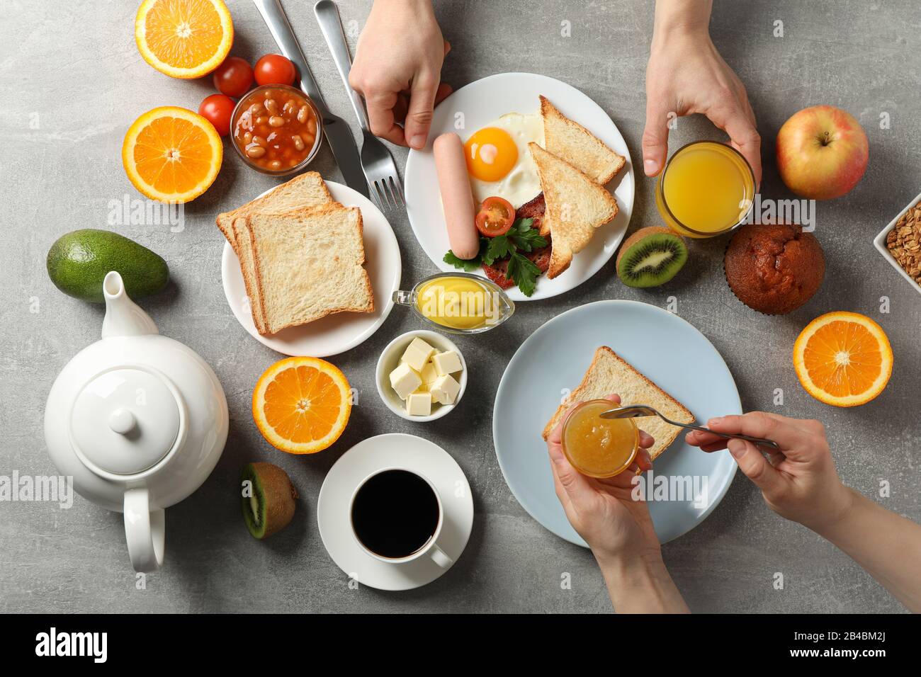 Delicious breakfast or lunch background. Grey table. People eat Stock ...