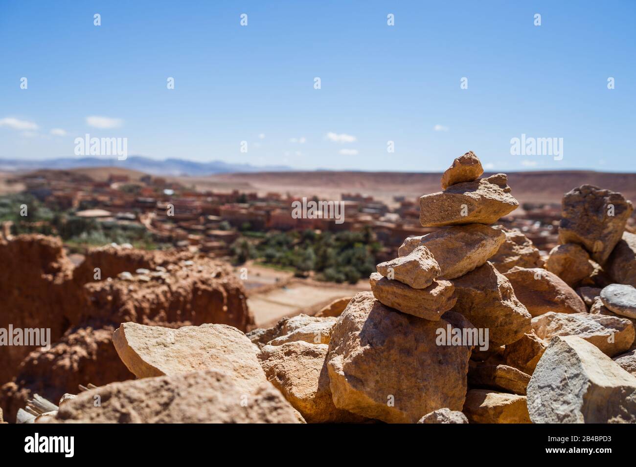 Image of stones in Morocco with village and desert behind.Focus on ...