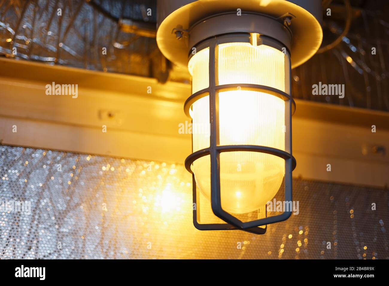 Industrial explosion-proof lantern of black and gray shines with white ...