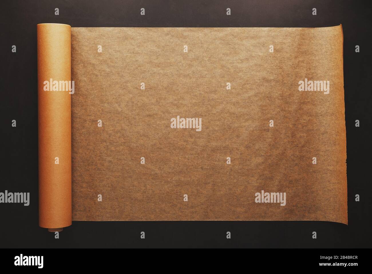 Vintage paper unfolded from a roll on a dark background. Papyrus ...