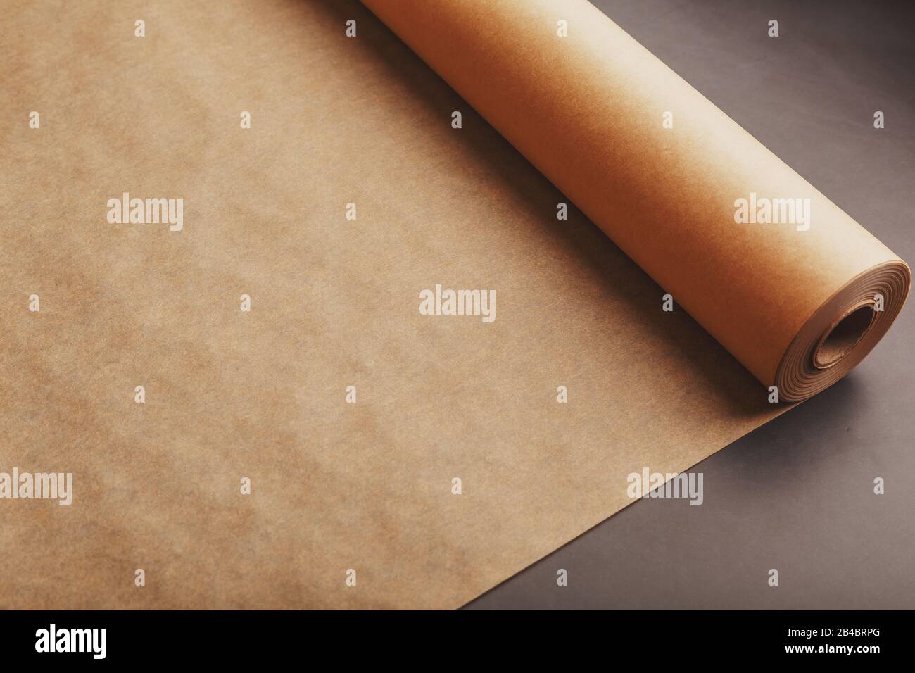 Vintage paper unfolded from a roll on a dark background. Papyrus ...