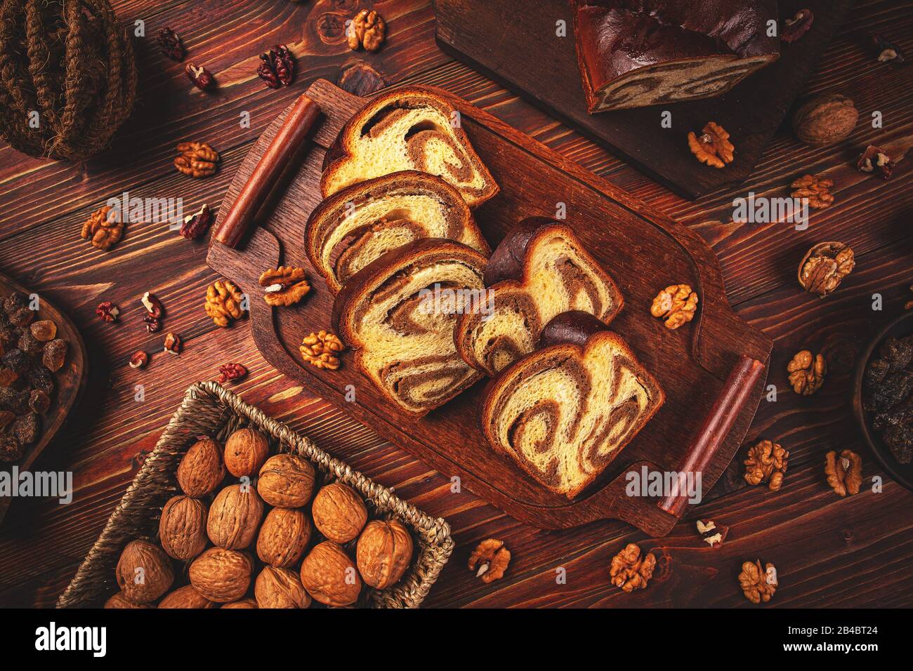 Flat lay of sliced sweet braided bread with walnuts Stock Photo - Alamy