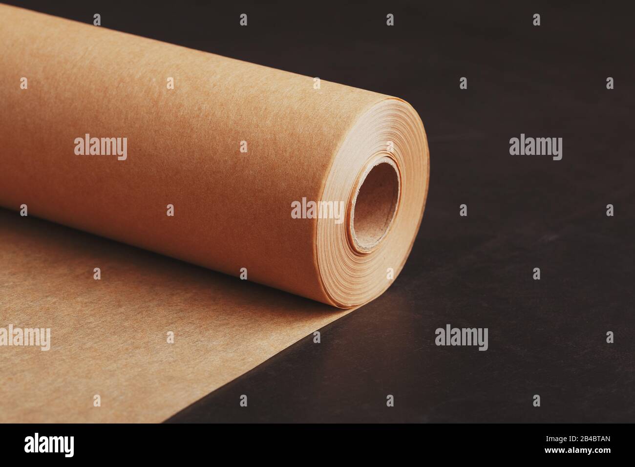 Vintage paper unfolded from a roll on a dark background. Papyrus ...