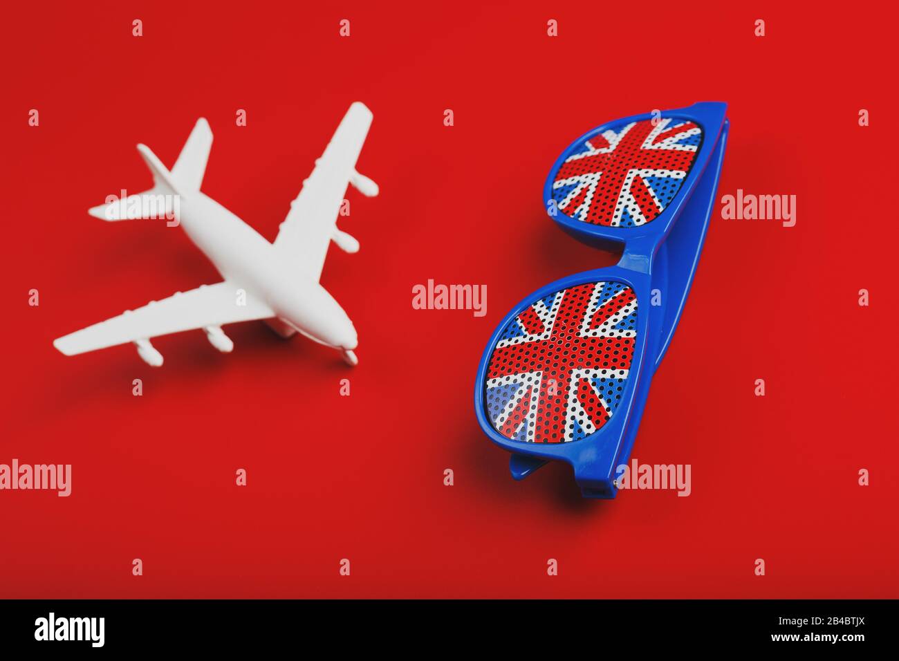 White airplane and sunglasses with the flag of the United Kingdom on a ...