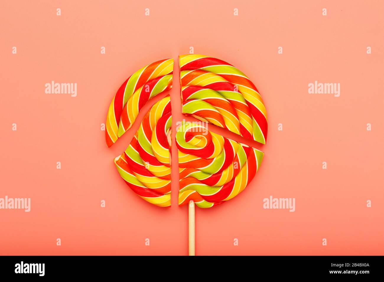 Lollipop broken into pieces on pink, red, blue background, top view ...