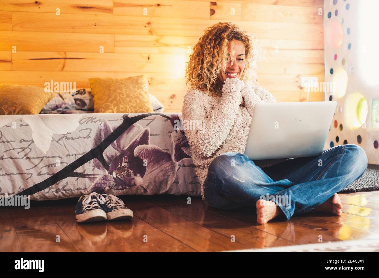 Beautifulyoung adult woman use technology at home with modern laptop ...