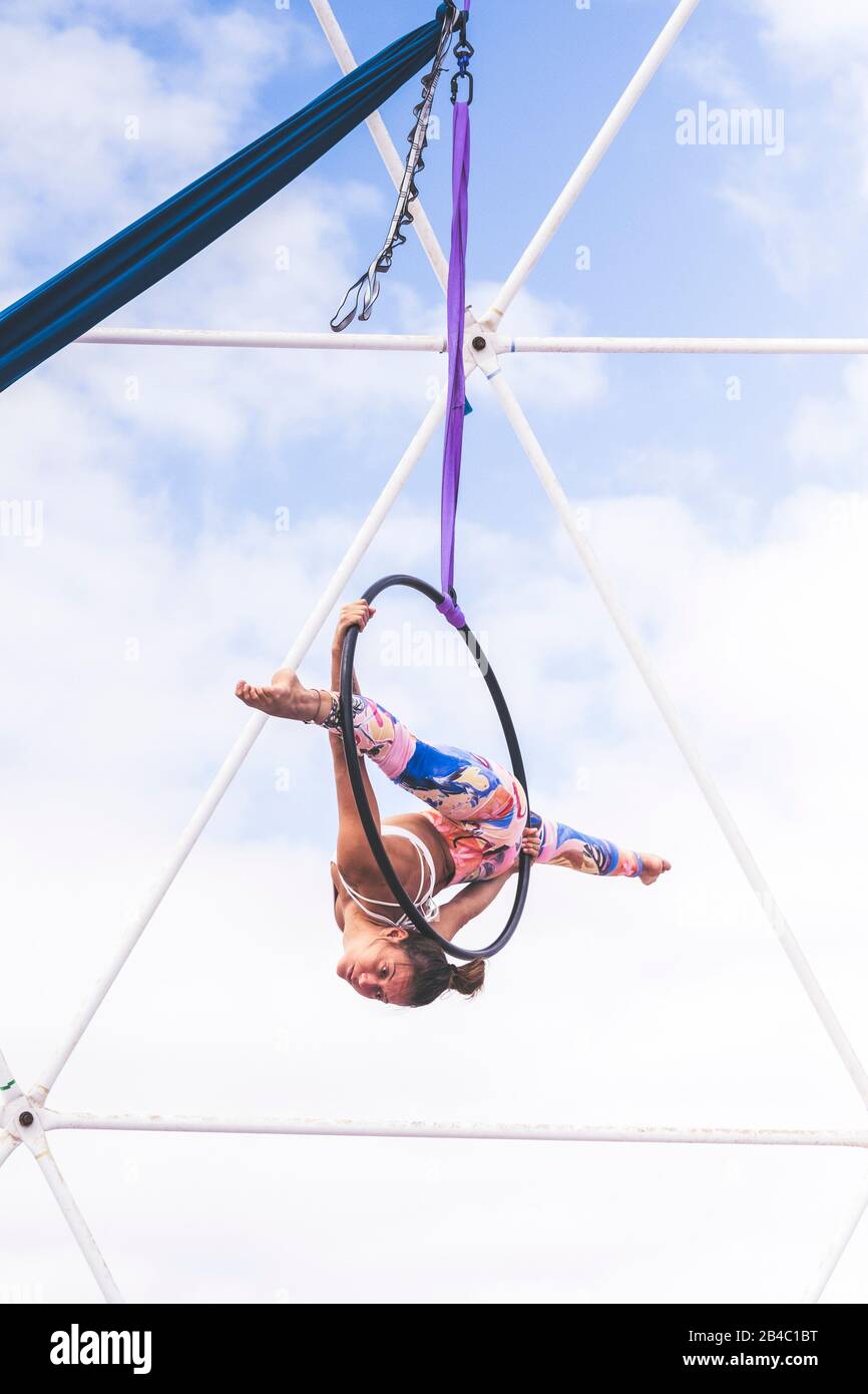 Young fitness perfect body people girl athlete do aerial exercises with ...