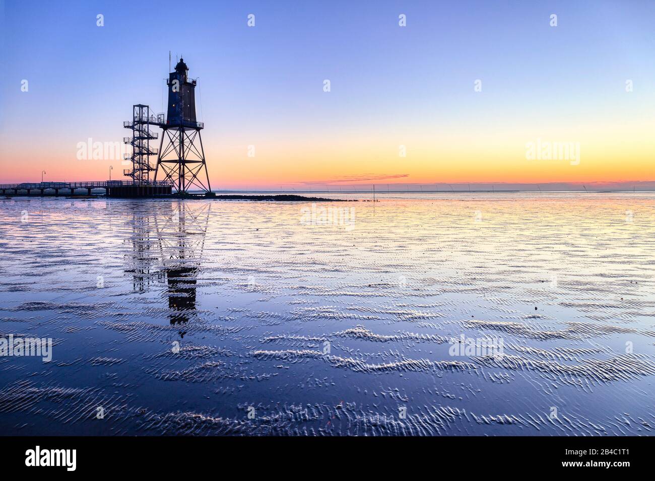 The lighthouse Obereversand near the village Dorum-Neufeld at sunset ...