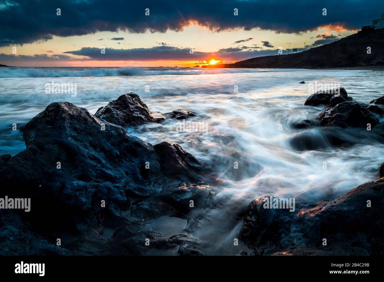 Cold coloured dramatic beautiful sunrise at the beach with ocean ...