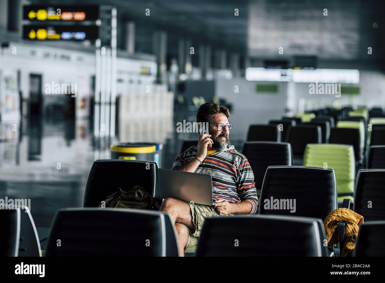Lonely man sit down and use technology device like laptop and mobile ...