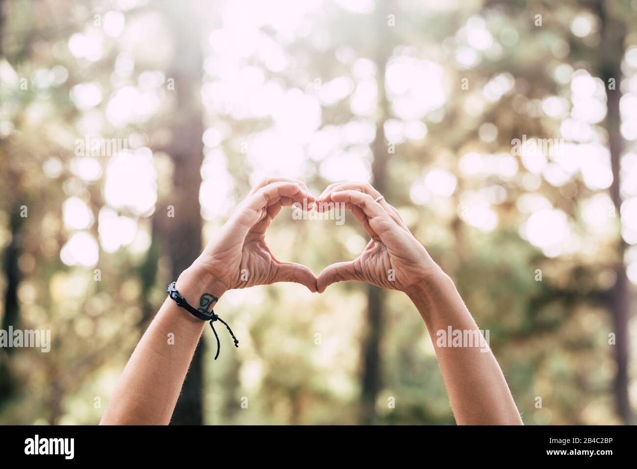 Earth's day concept with pair of human people hang doing hearth symbol ...