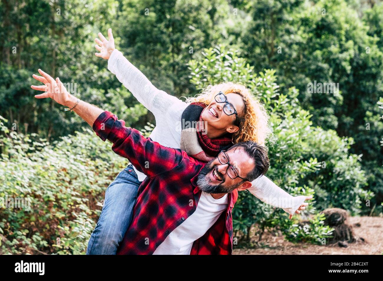 Happy couple of adult people caucasian man and woman have fun together ...