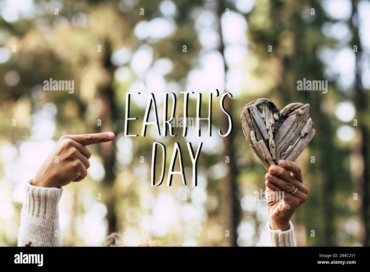 Earth's day text message with human people hands taking a wood hearth ...