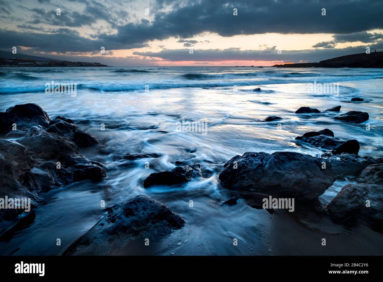 Cold coloured dramatic beautiful sunrise at the beach with ocean ...