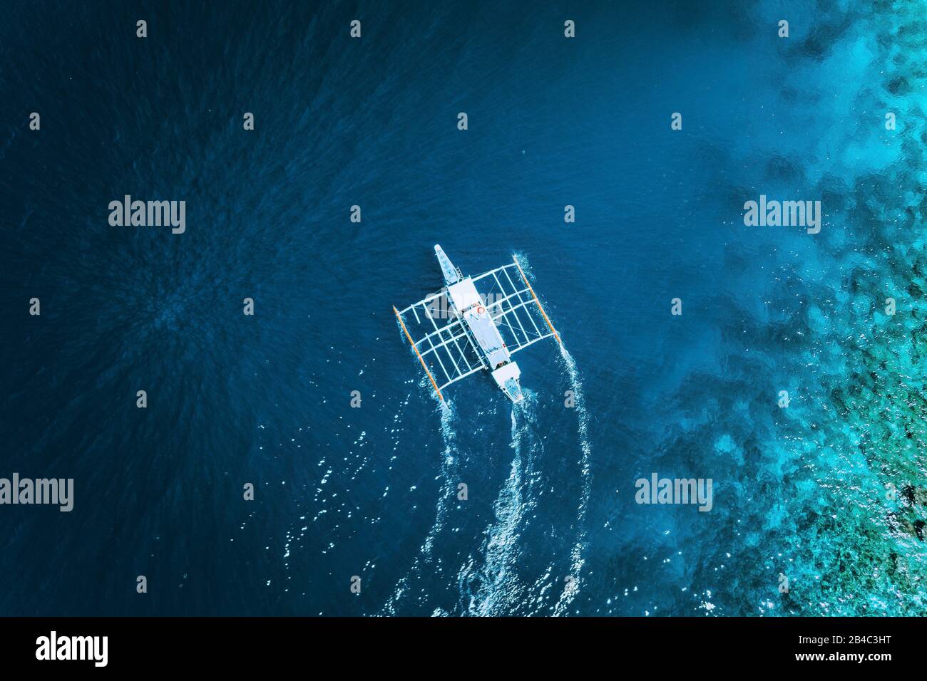 Aerial drone view of white traditional Filipino boat floating on top of ...