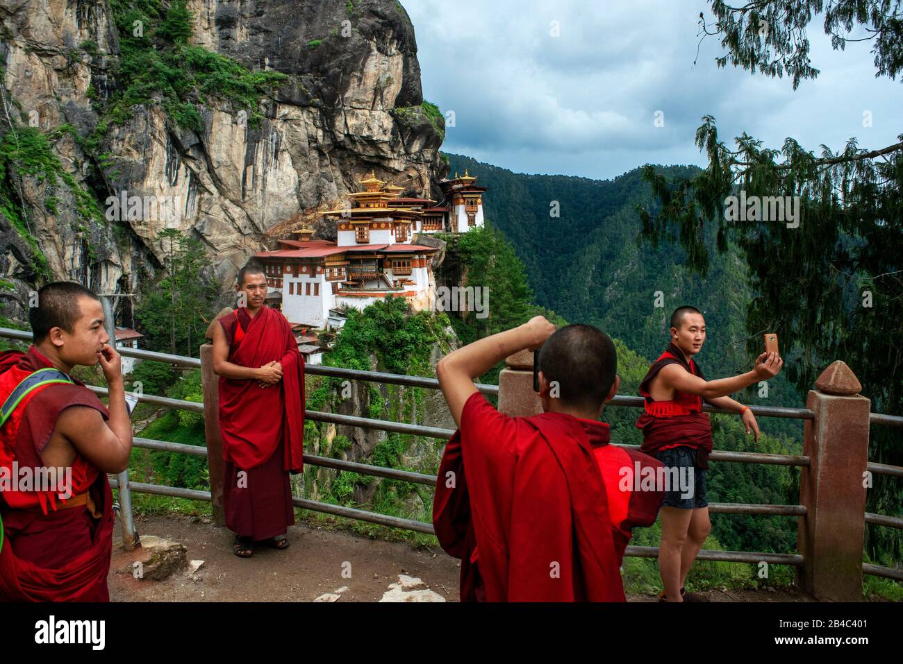 Monks In The Taktsang Goemba Or Tigers Nest Monastery In Paro Valley
