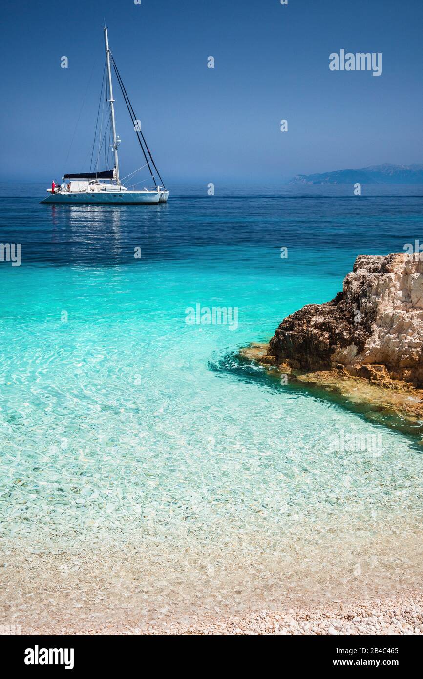 Beautiful calm azure blue lagoon with sailing catamaran yacht boat at ...