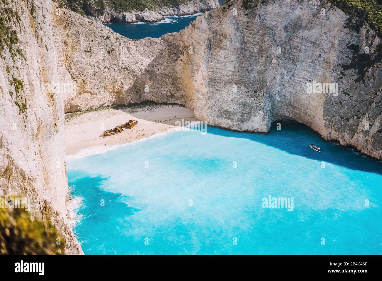 Navagio beach with turquoise blue sea water surrounded by huge white ...