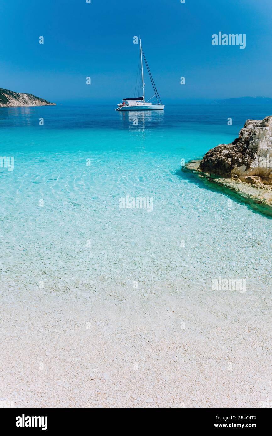 Beautiful azure blue lagoon with sailing catamaran yacht boat at anchor ...