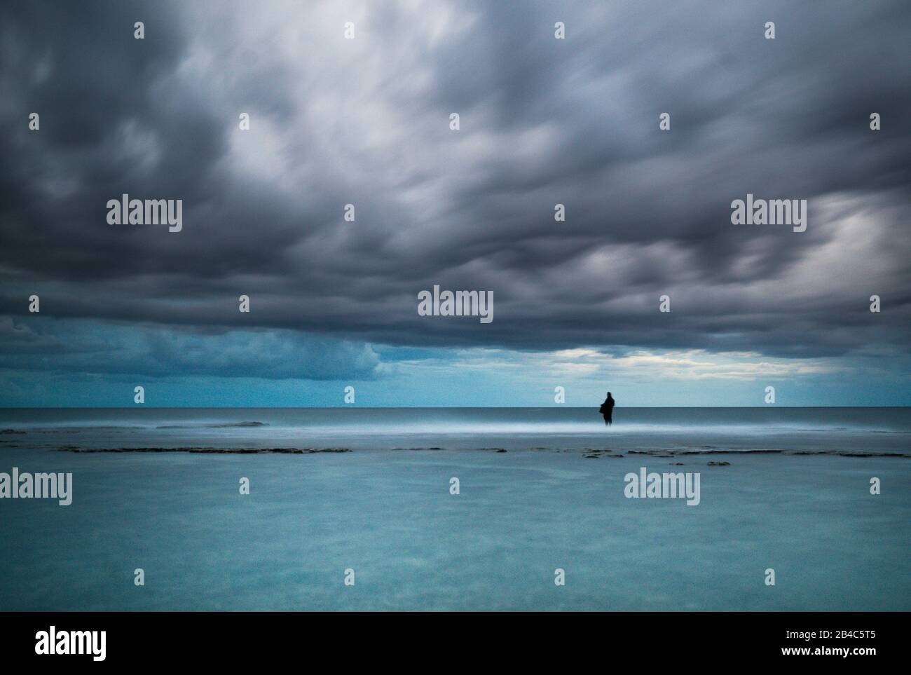 Clouds and wind storm weather and man Stock Photo - Alamy