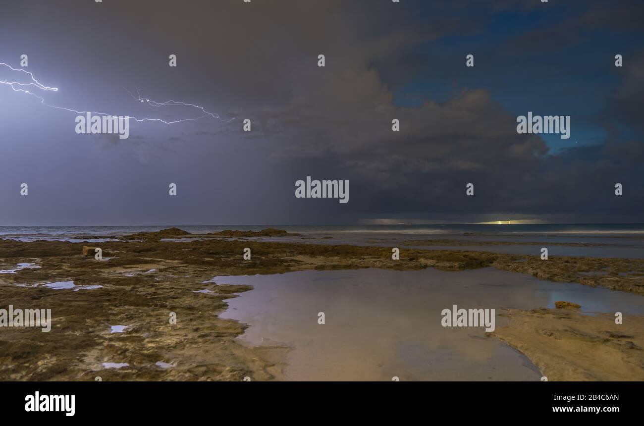Storm weather with lightning on sea beach Stock Photo - Alamy