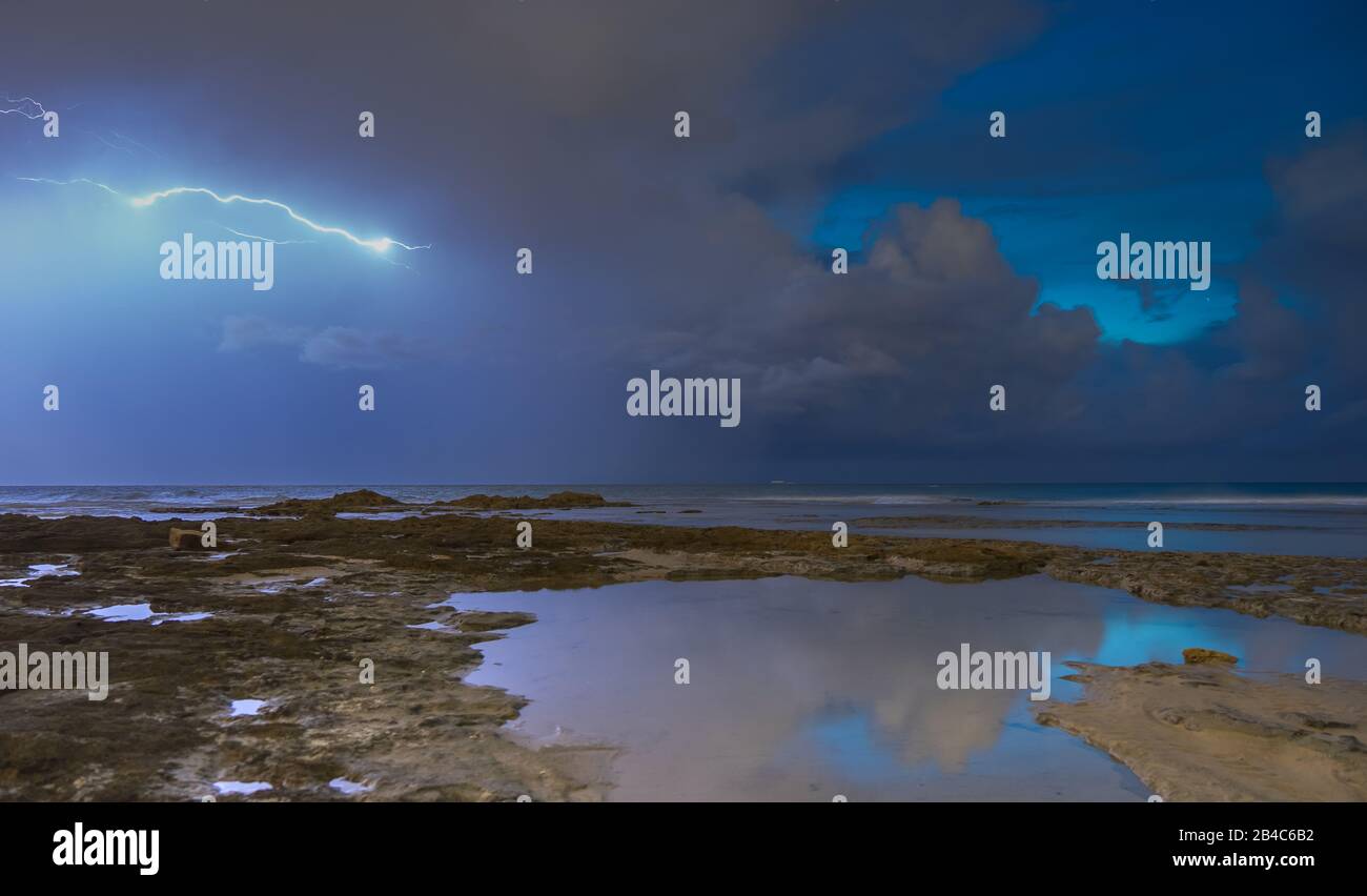 Storm weather with lightning on sea beach Stock Photo - Alamy