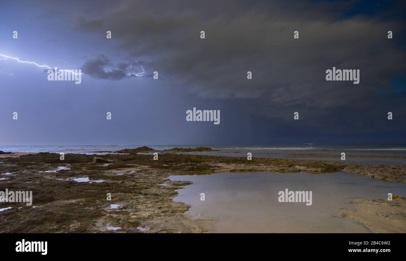 Storm weather with lightning on sea beach Stock Photo - Alamy