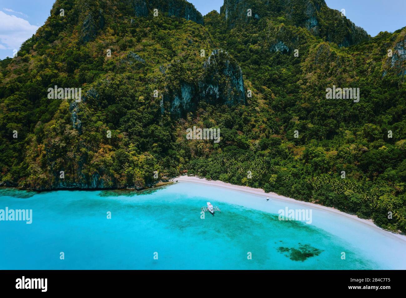 Aerial drone view of uninhabited tropical island with rugged mountains ...