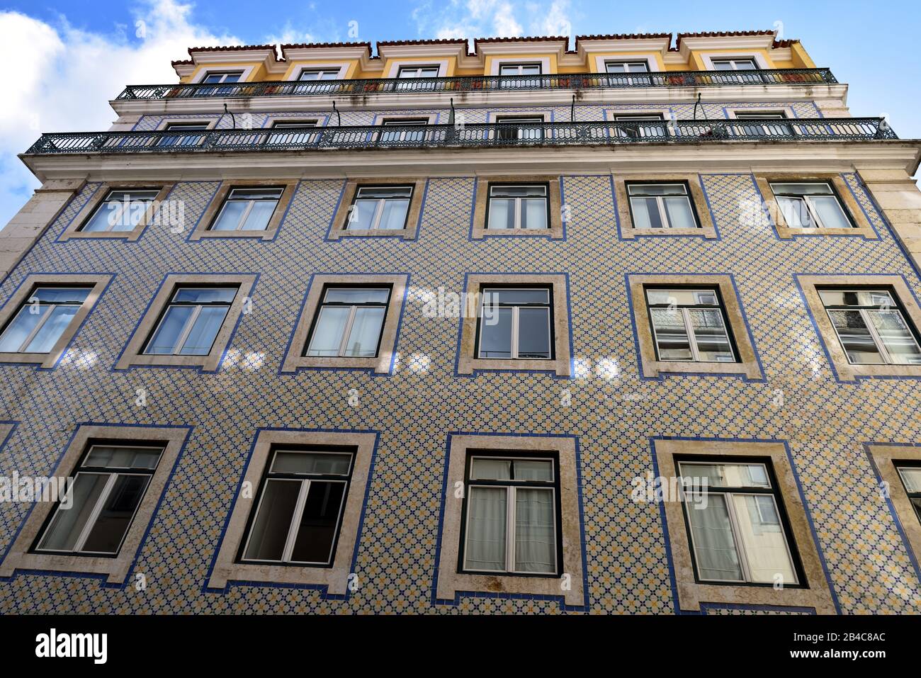 Blue and yellow tiled building facade Stock Photo - Alamy